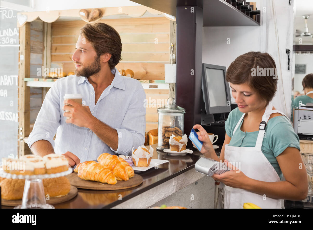 Pretty waitress serving happy customer Stock Photo - Alamy