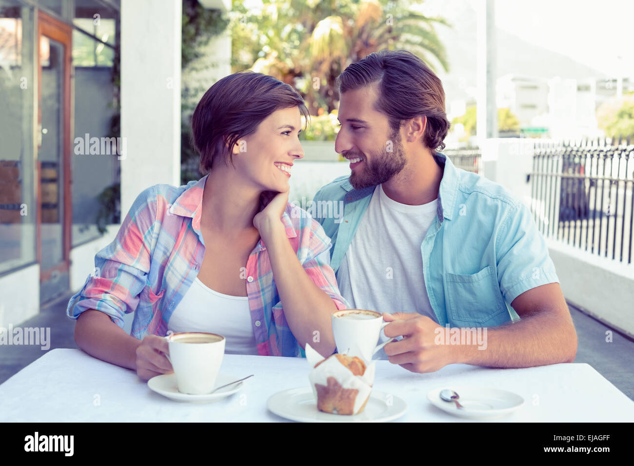 Happy couple enjoying coffee together Stock Photo - Alamy