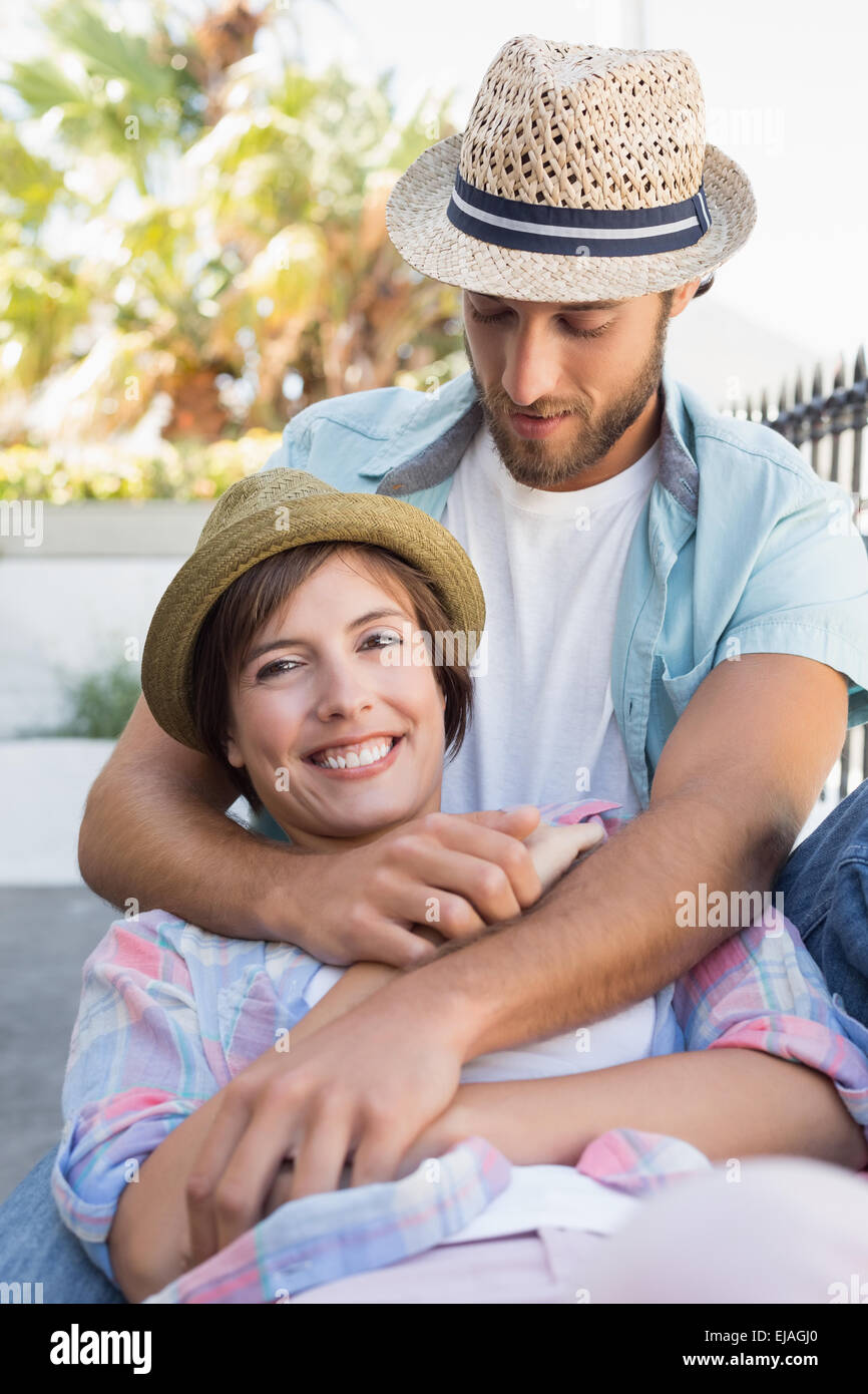 Happy couple sitting and cuddling Stock Photo - Alamy