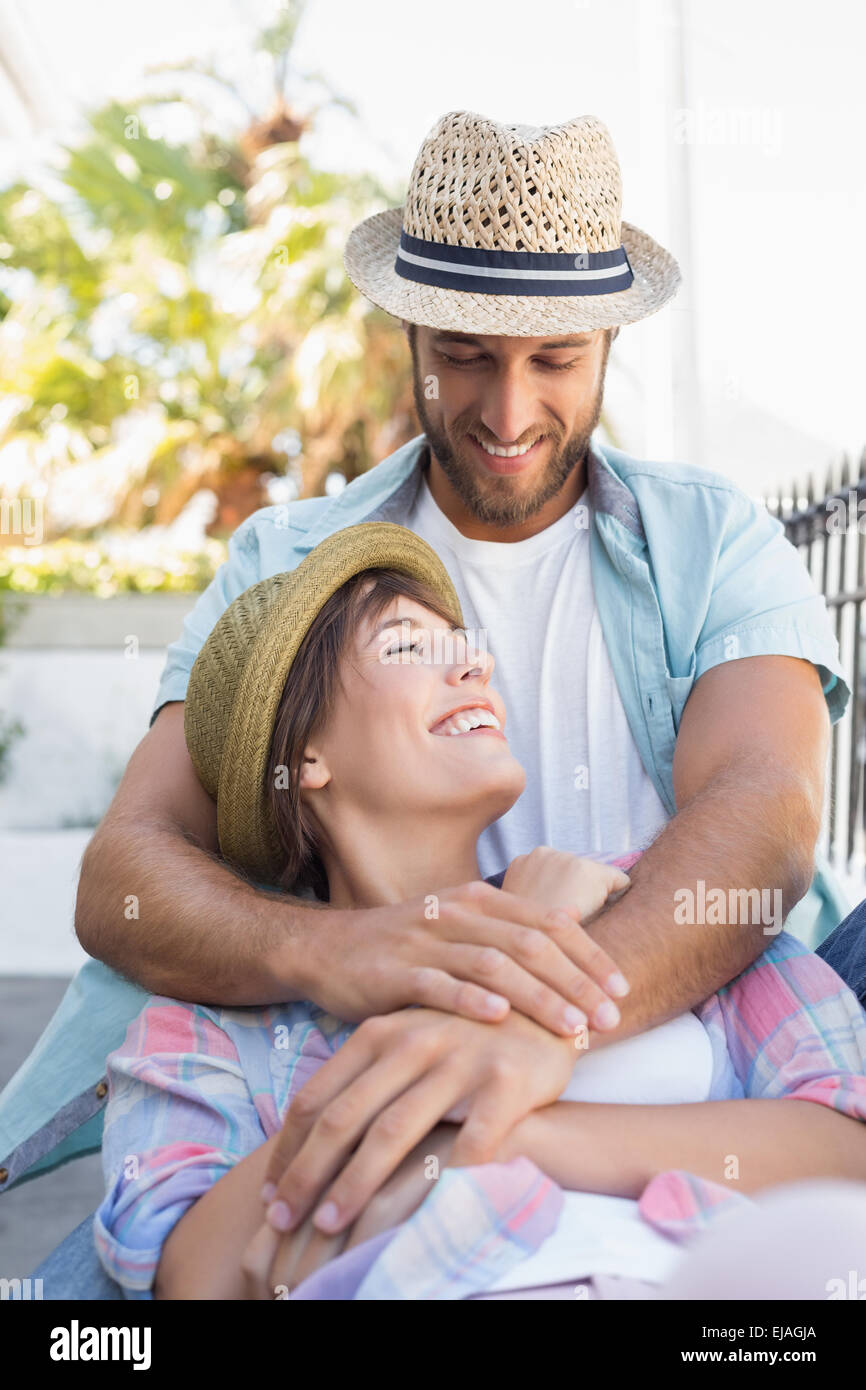 Happy couple sitting and cuddling Stock Photo - Alamy