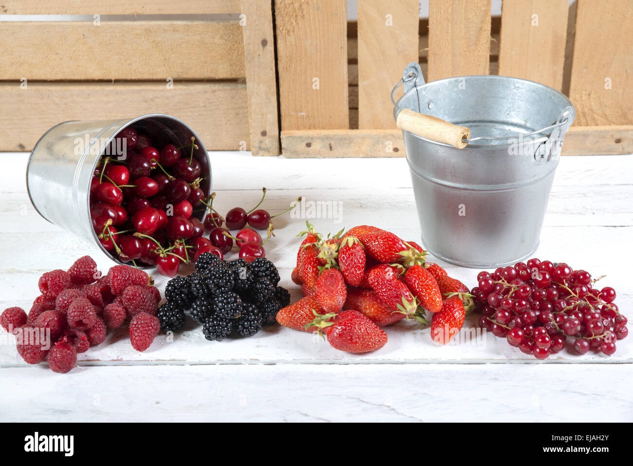 assortment of red fruit on the white table Stock Photo - Alamy