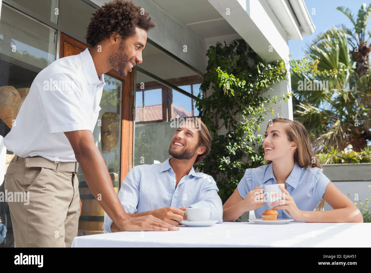 Happy friends having coffee together Stock Photo - Alamy