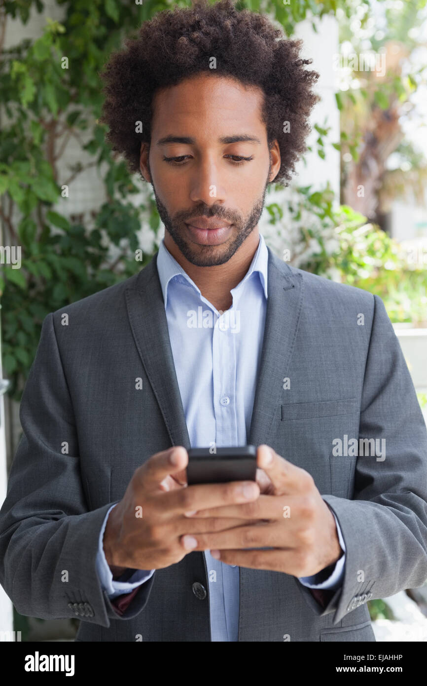 Handsome businessman texting on phone Stock Photo - Alamy