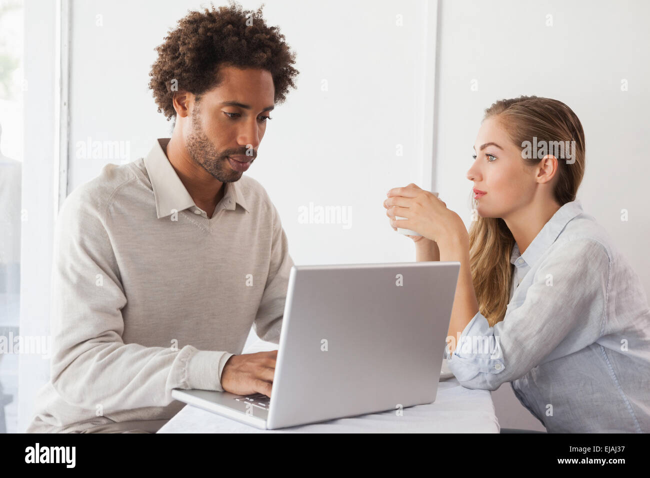 Happy couple on a date using laptop Stock Photo - Alamy