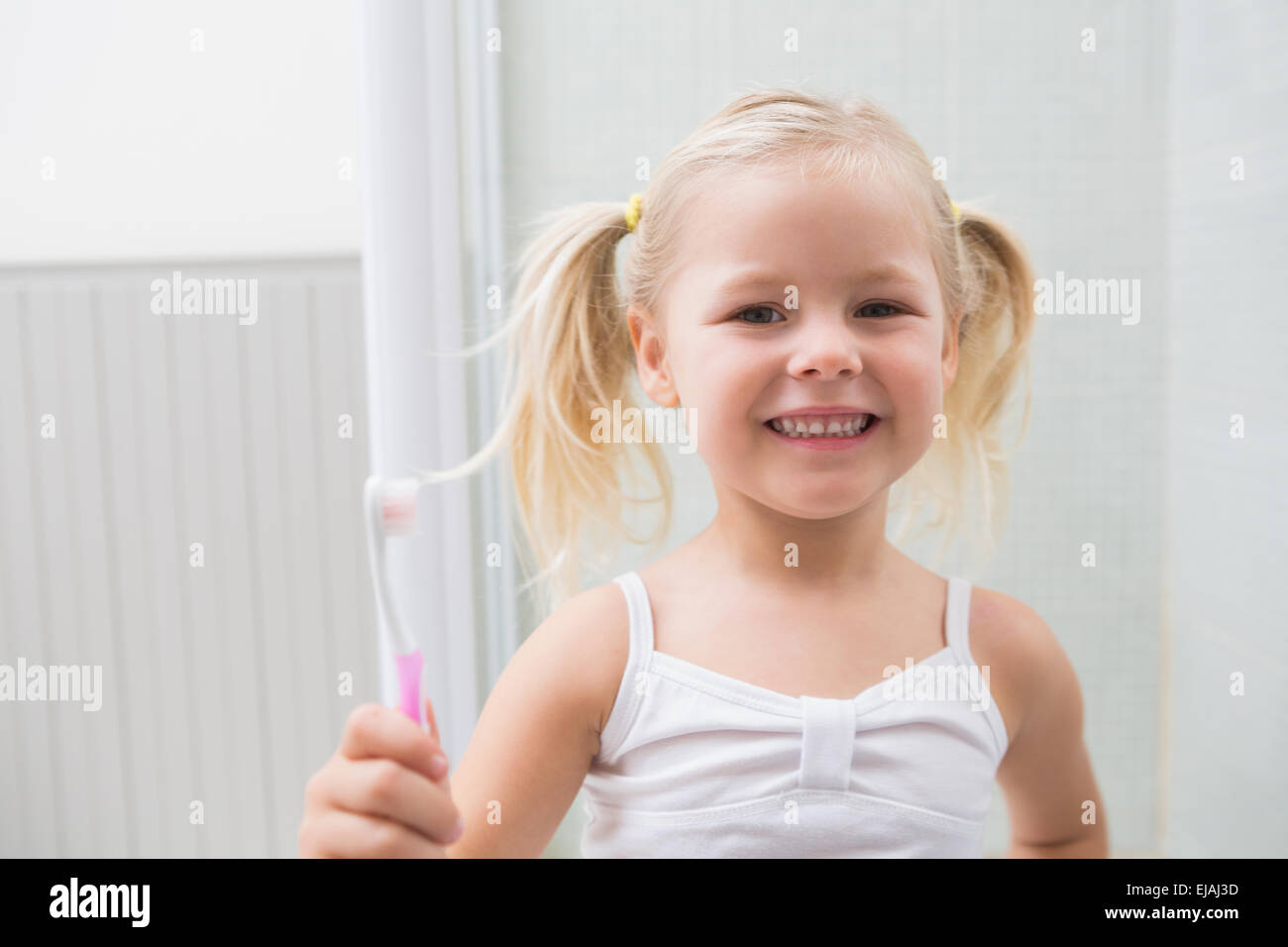 Cute girl brushing her teeth Stock Photo - Alamy