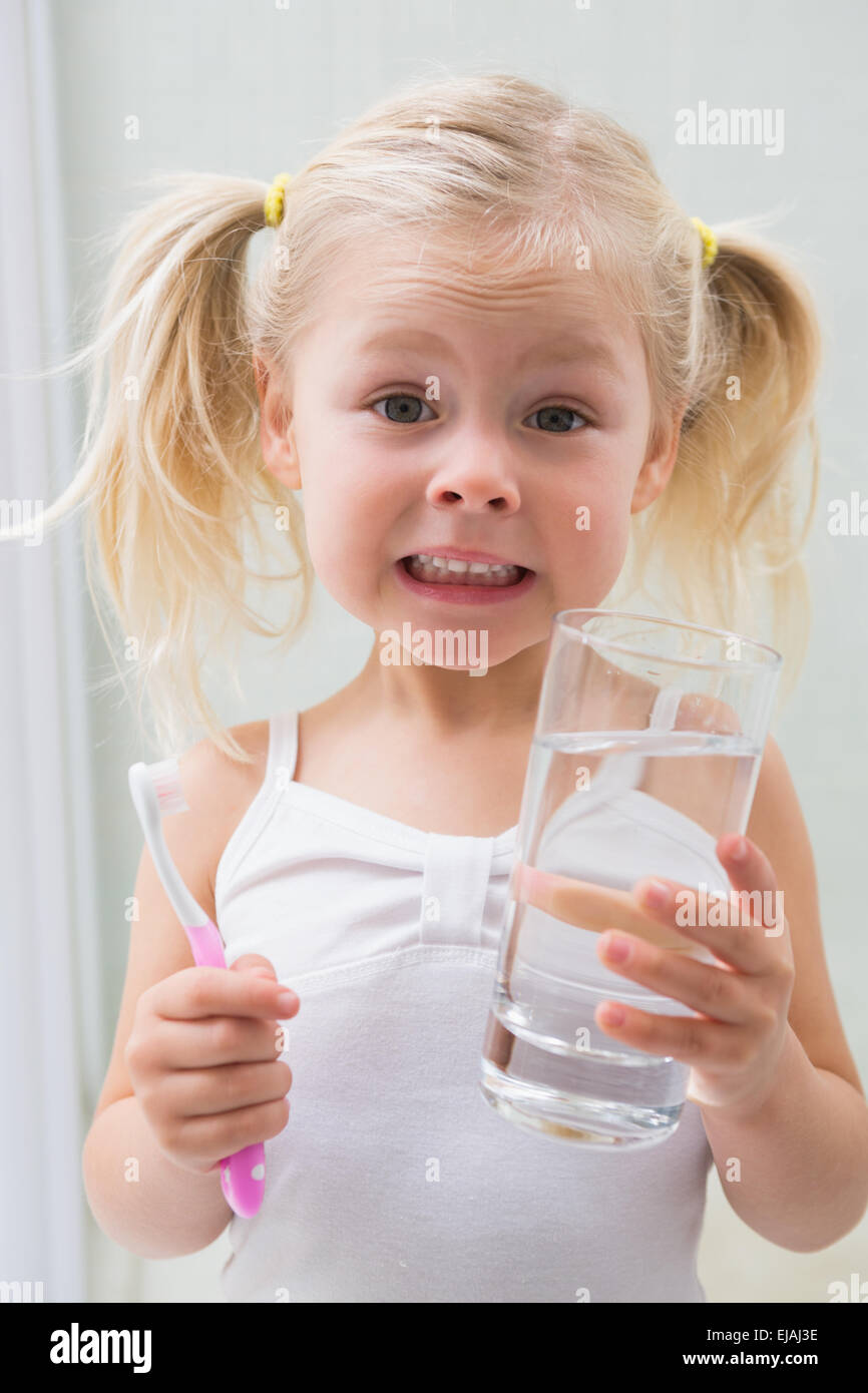 Cute girl brushing her teeth Stock Photo - Alamy