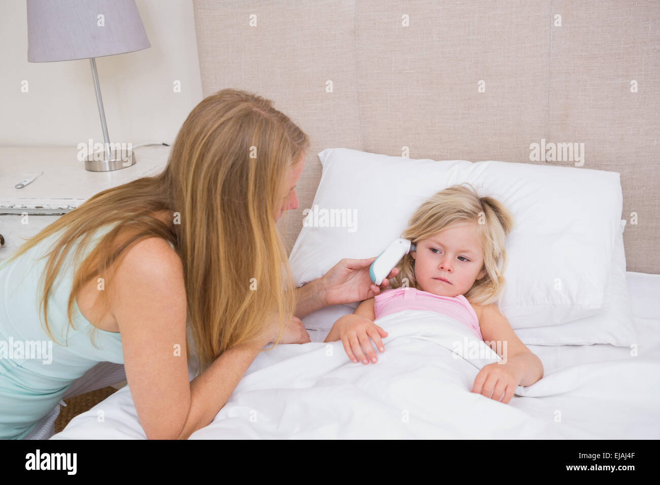 Cute sick girl being looked after Stock Photo - Alamy
