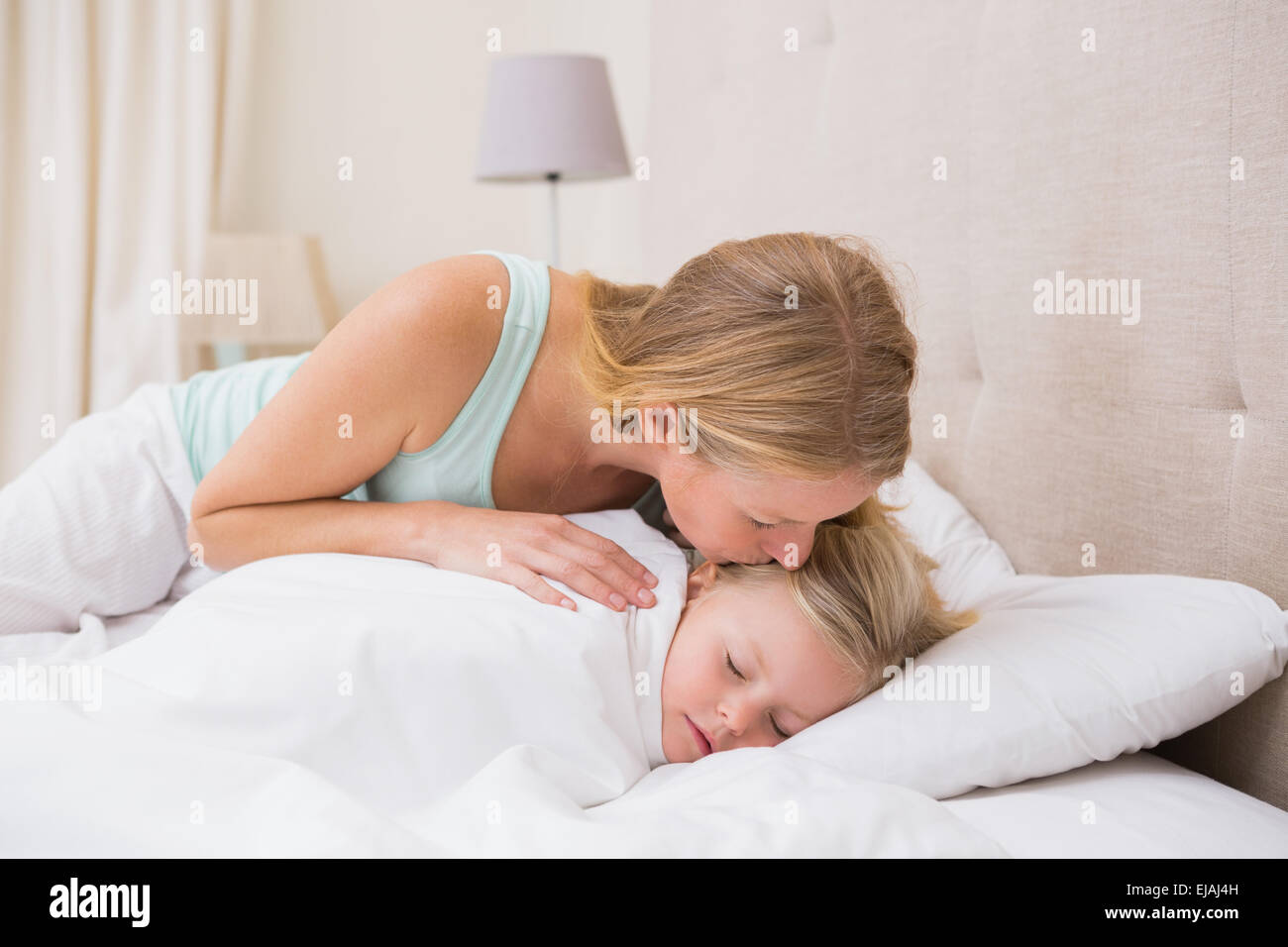 Mother tucking in daughter hi-res stock photography and images - Alamy