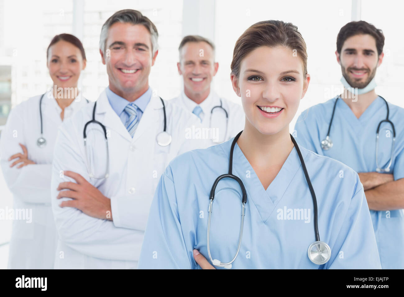 Smiling doctors all standing together Stock Photo - Alamy