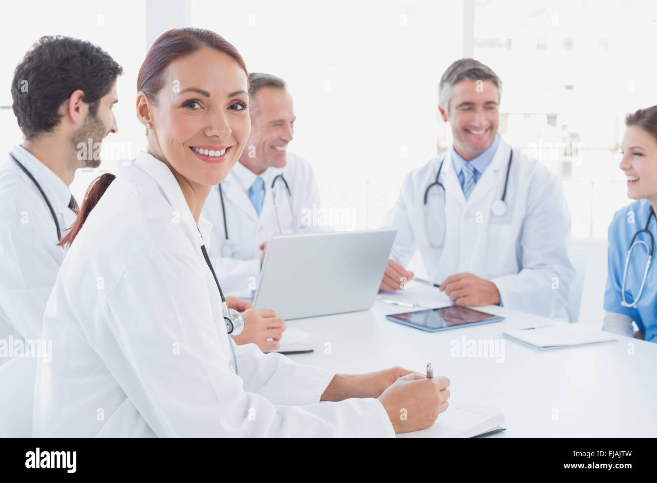 Doctors smiling and working together Stock Photo - Alamy