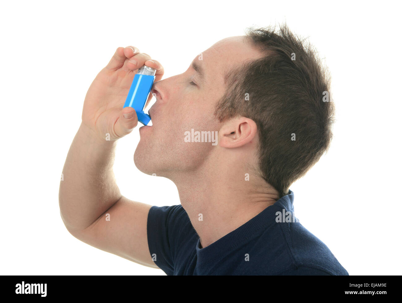 Young man using an asthma inhaler as prevention Stock Photo - Alamy