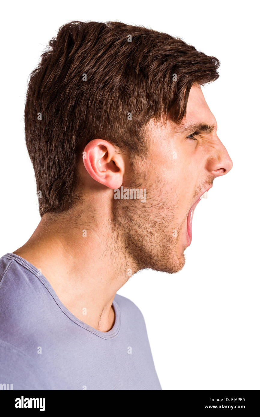 Angry young man with stubble shouting Stock Photo - Alamy