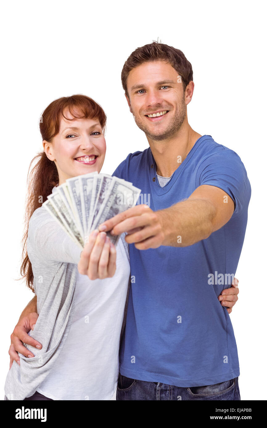 Couple holding fan of cash Stock Photo - Alamy