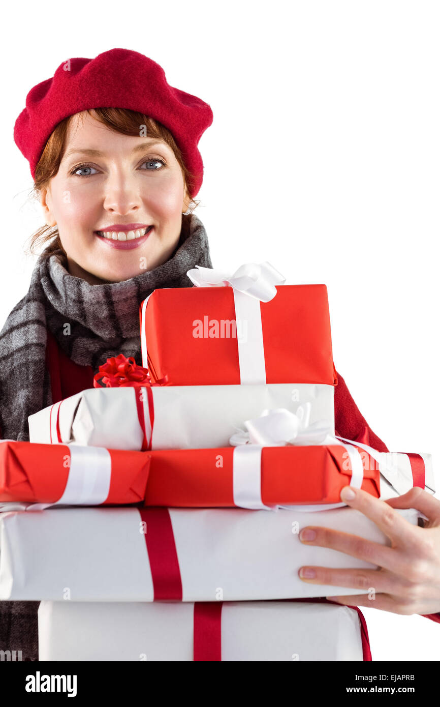 Smiling woman holding large presents Stock Photo - Alamy