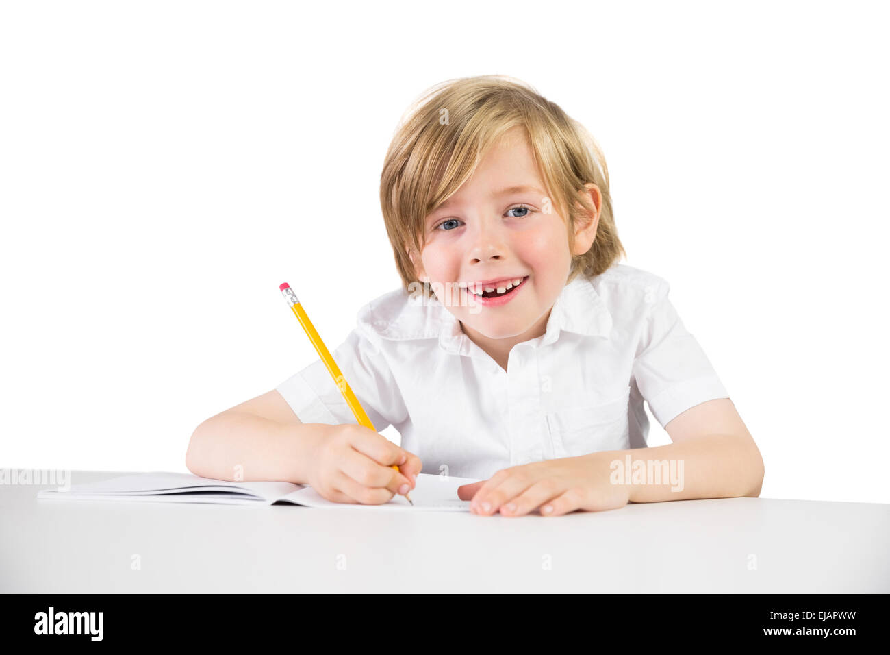 Happy child writing down homework Stock Photo - Alamy
