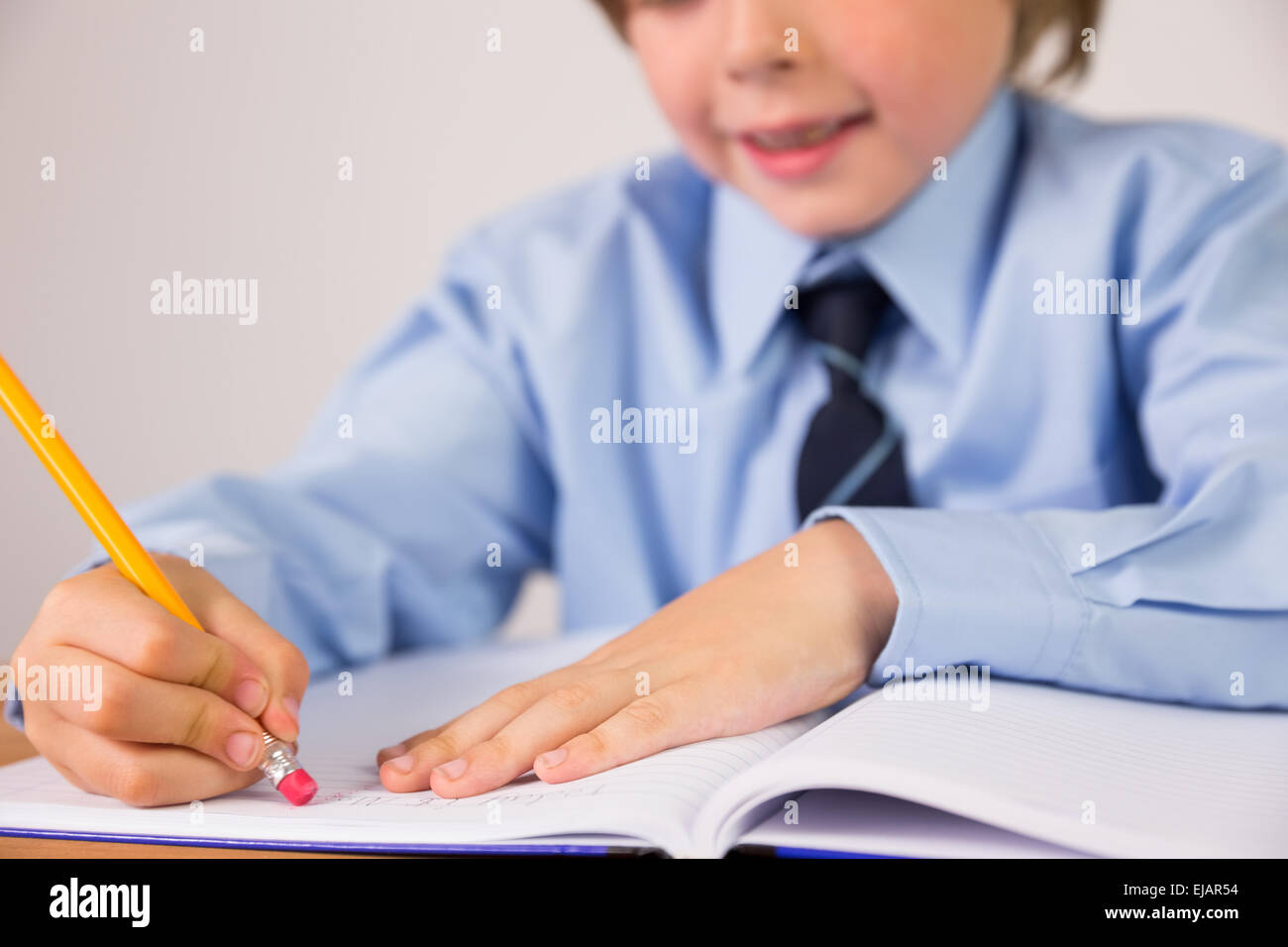 Student writing notes in notepad Stock Photo - Alamy