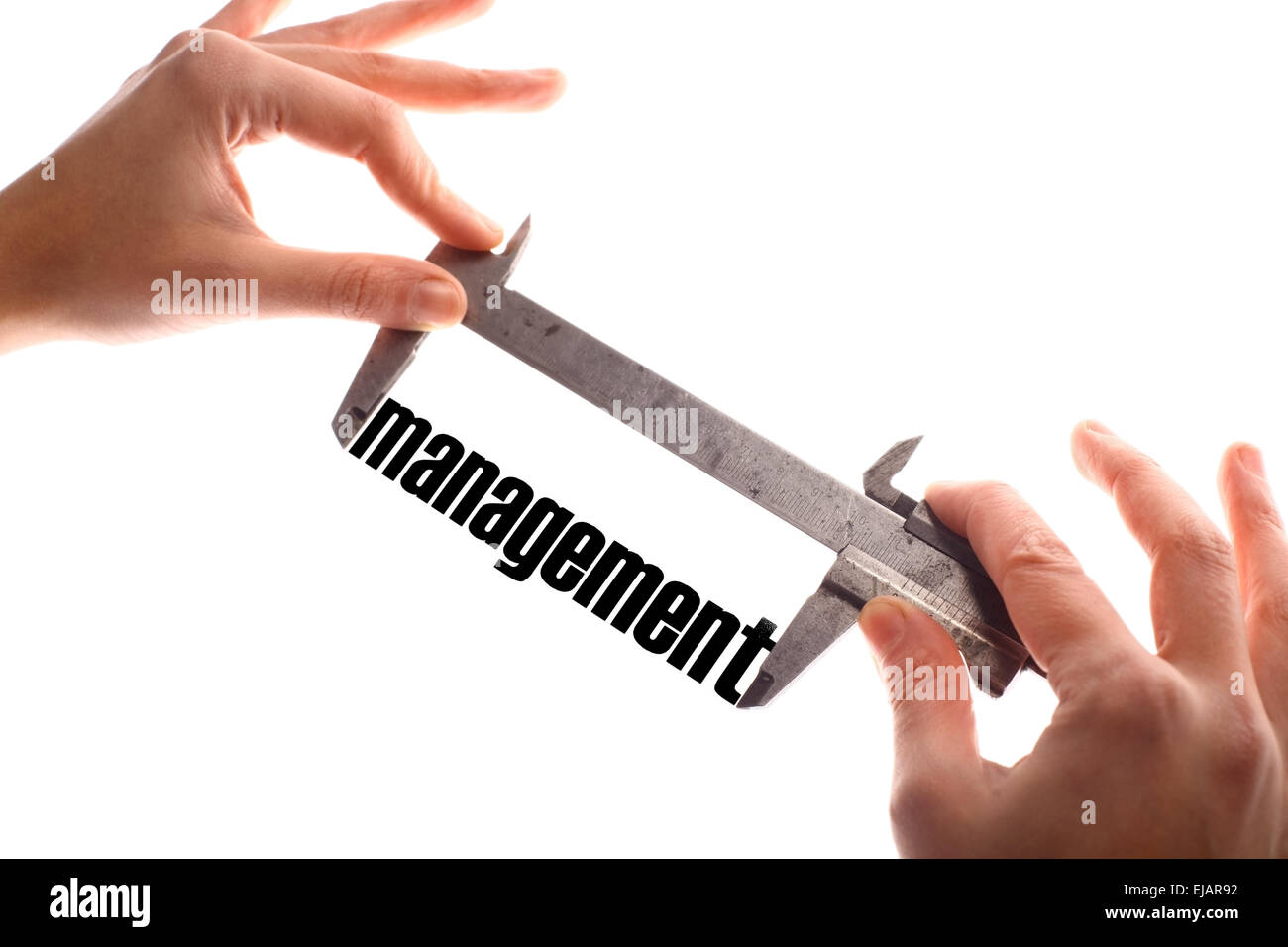Color horizontal shot of two hands holding a caliper measuring the word ...