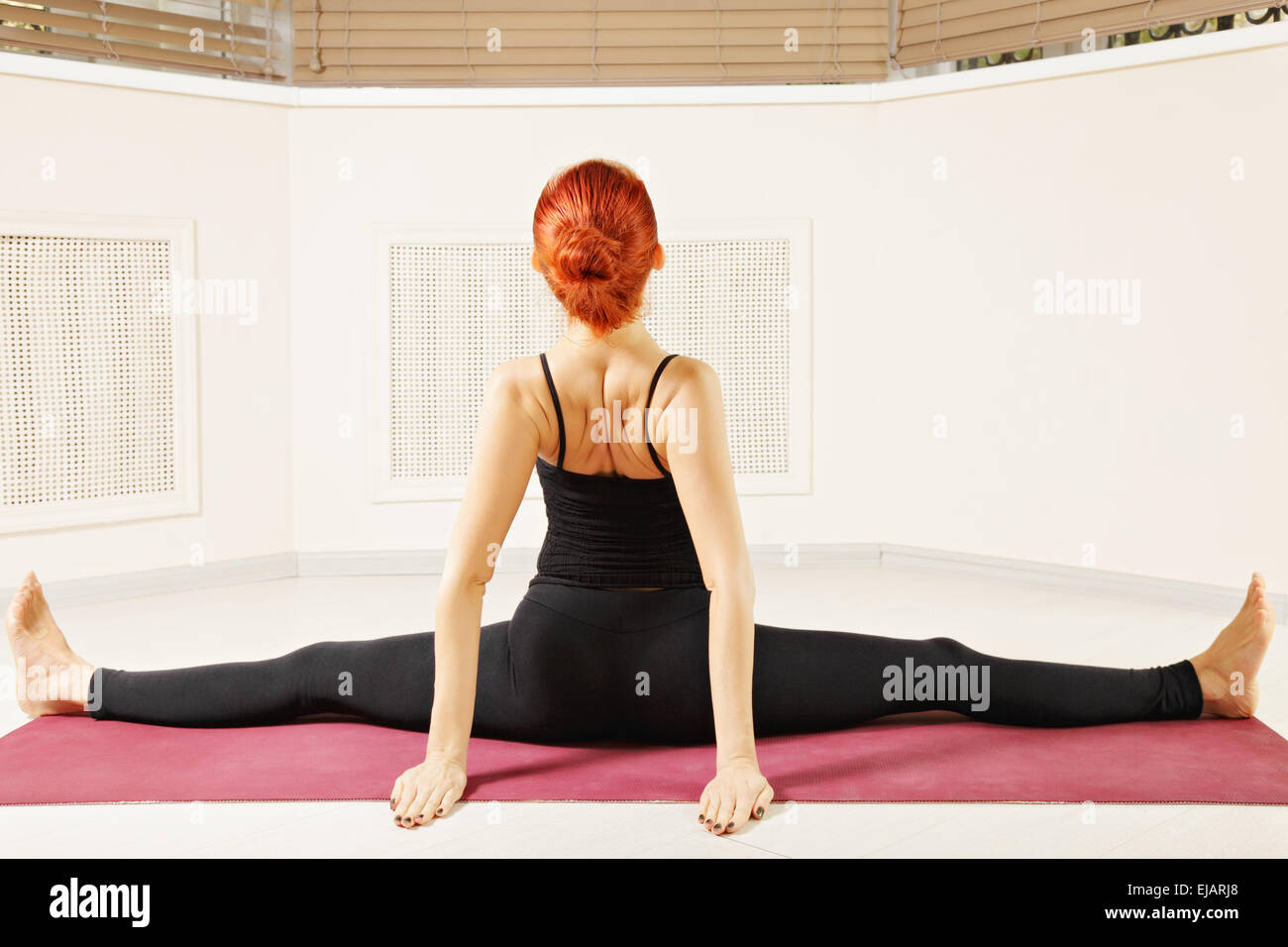 Woman stretching legs out arms behind Stock Photo - Alamy