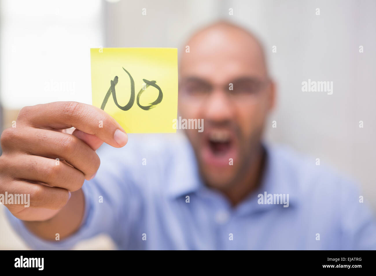 Businessman holding paper that says NO Stock Photo - Alamy