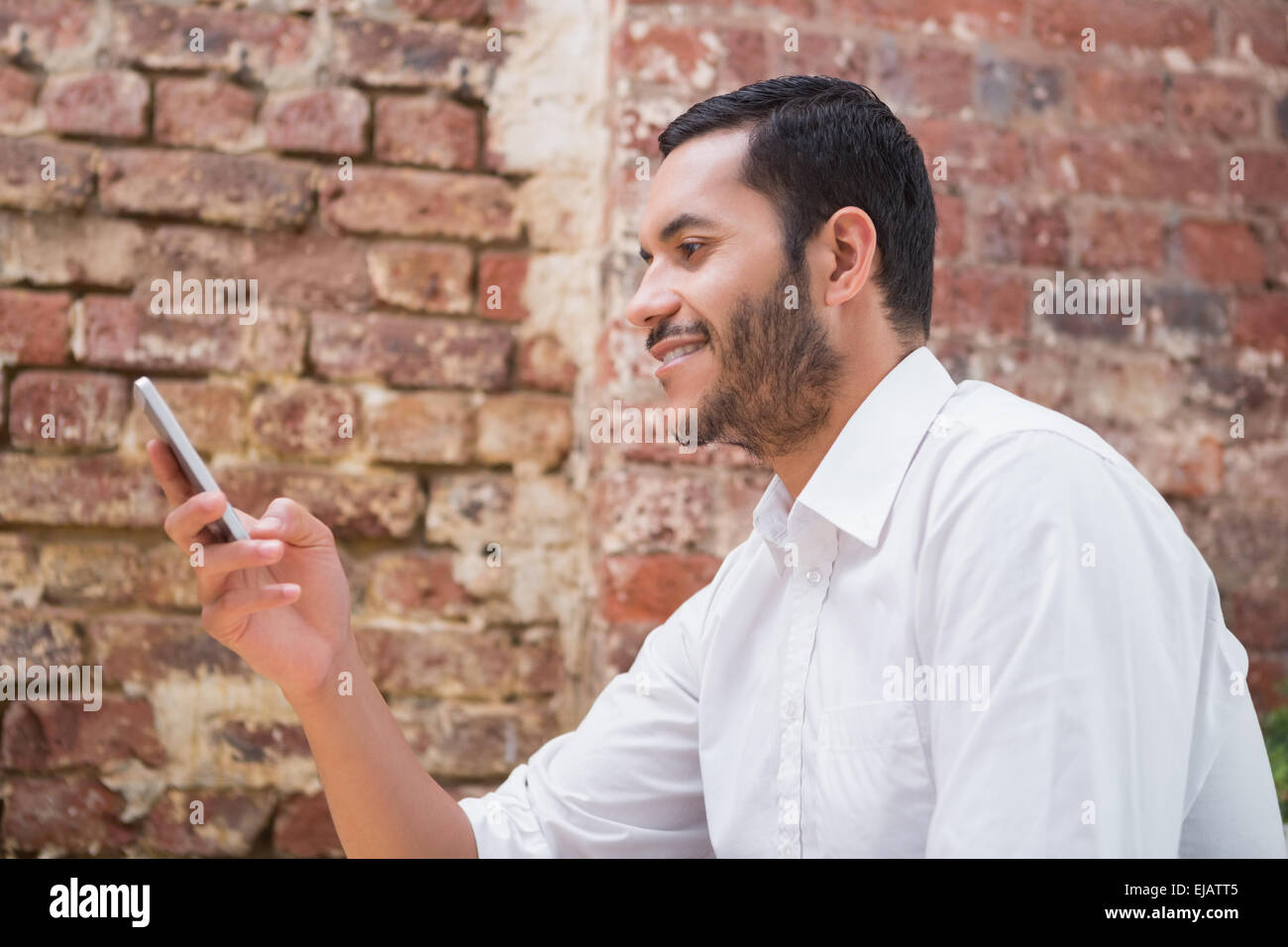 Young businessman text messaging Stock Photo - Alamy