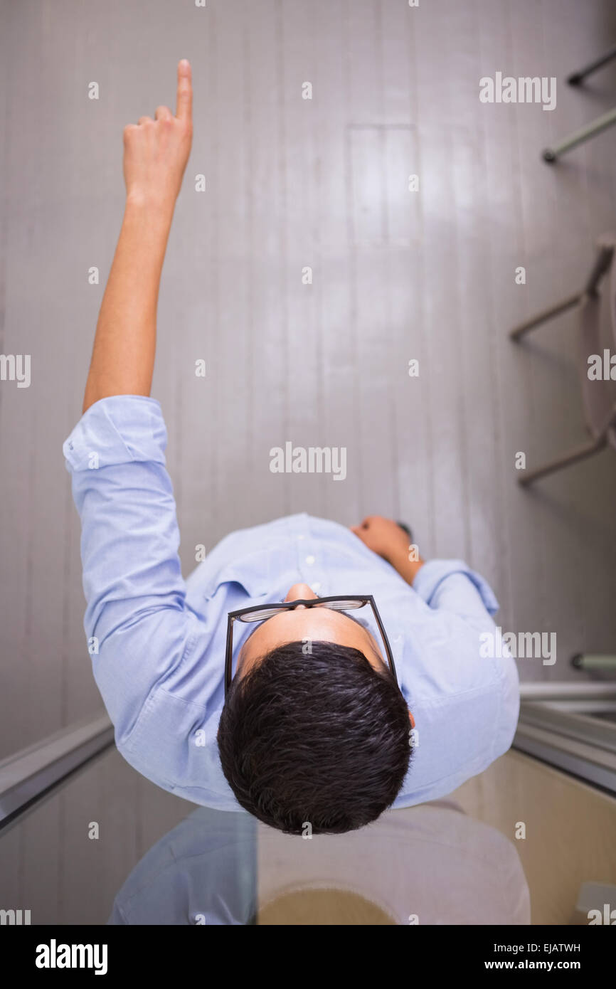 Businessman pointing away in office Stock Photo - Alamy
