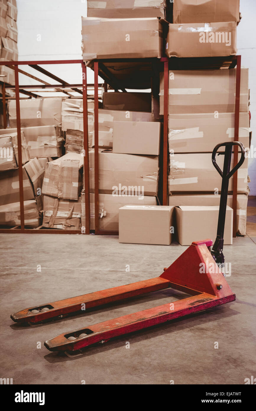 Storage cart on floor in warehouse Stock Photo - Alamy