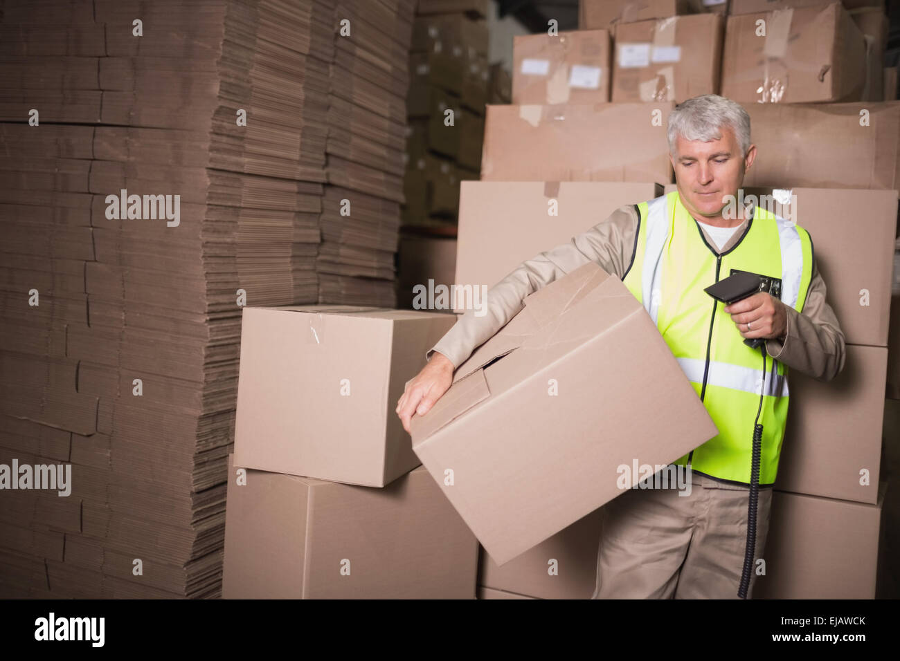 Worker scanning package in warehouse Stock Photo - Alamy