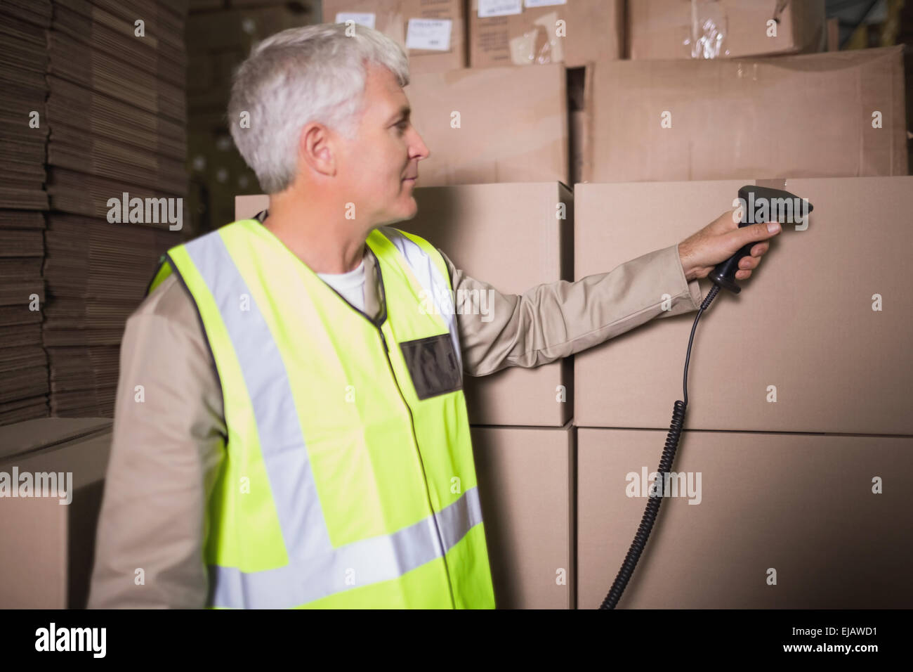 Worker scanning package in warehouse Stock Photo - Alamy