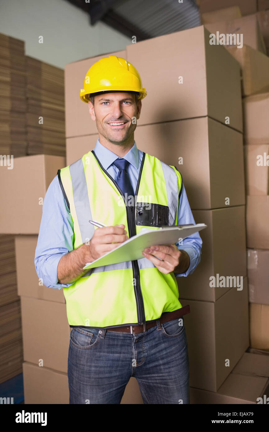 Portrait of warehouse worker with clipboard Stock Photo - Alamy