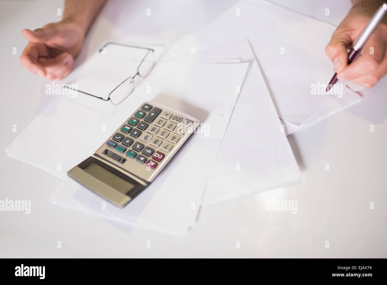 Bills and calculator on table Stock Photo - Alamy
