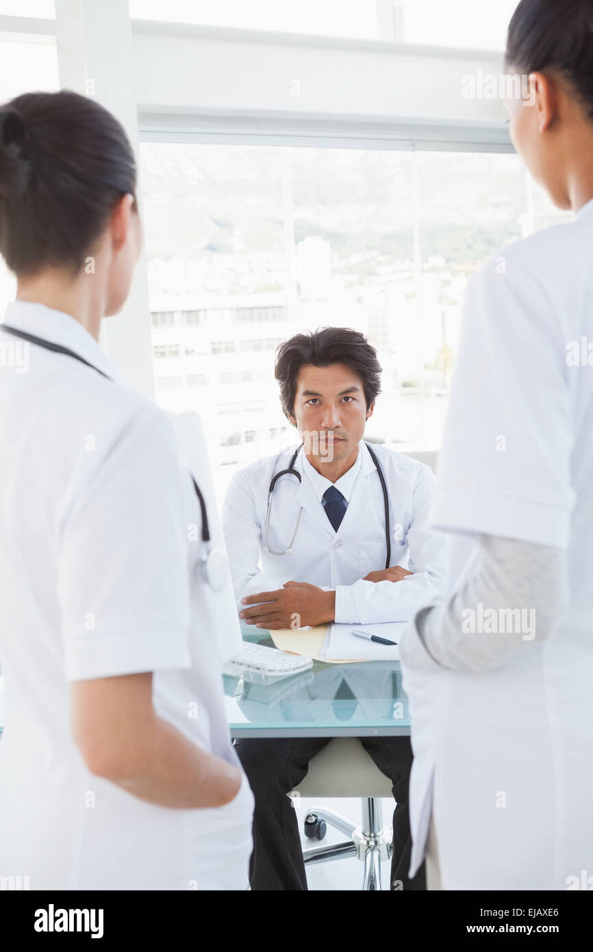 Serious doctor looking at the camera Stock Photo - Alamy