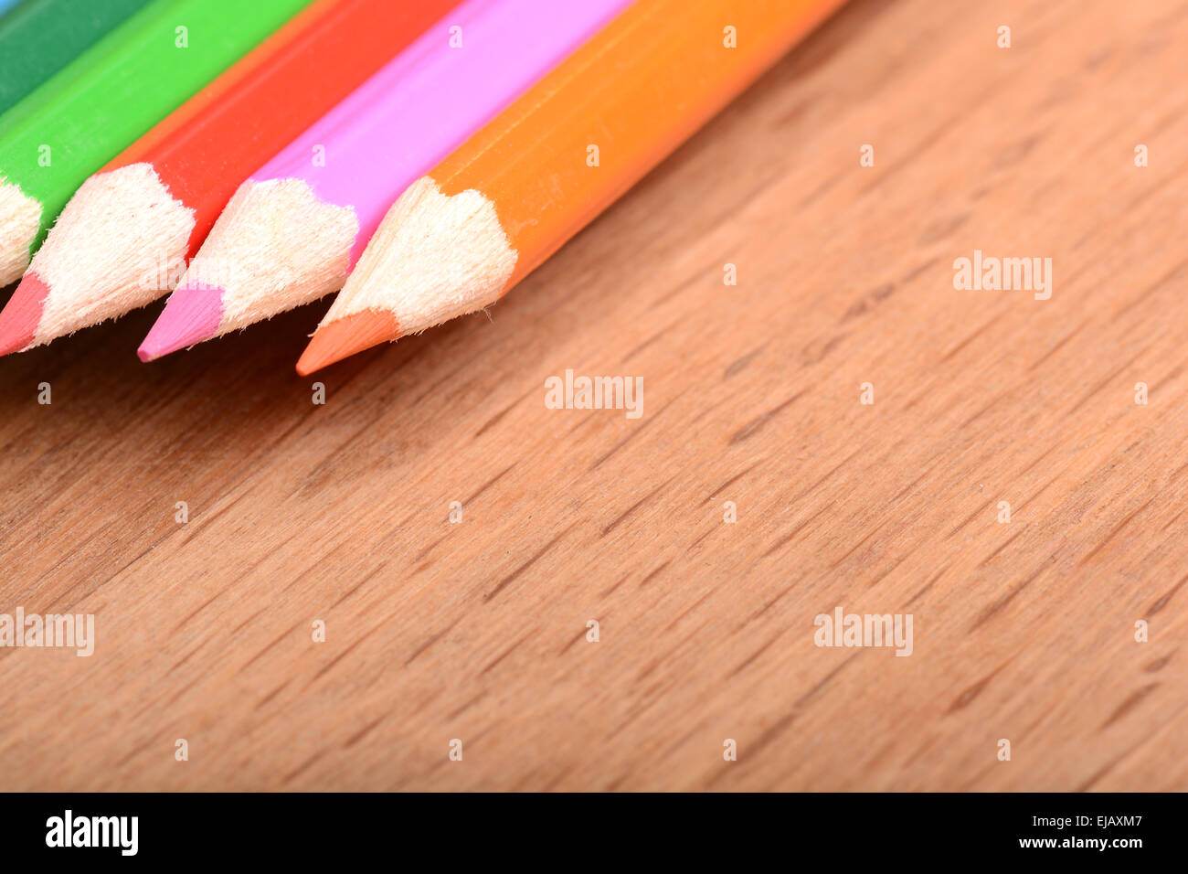 colored pencils on wooden background Stock Photo - Alamy