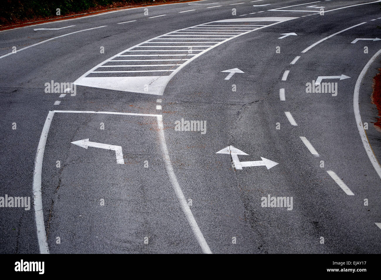 Road with turn direction lane marks Stock Photo - Alamy