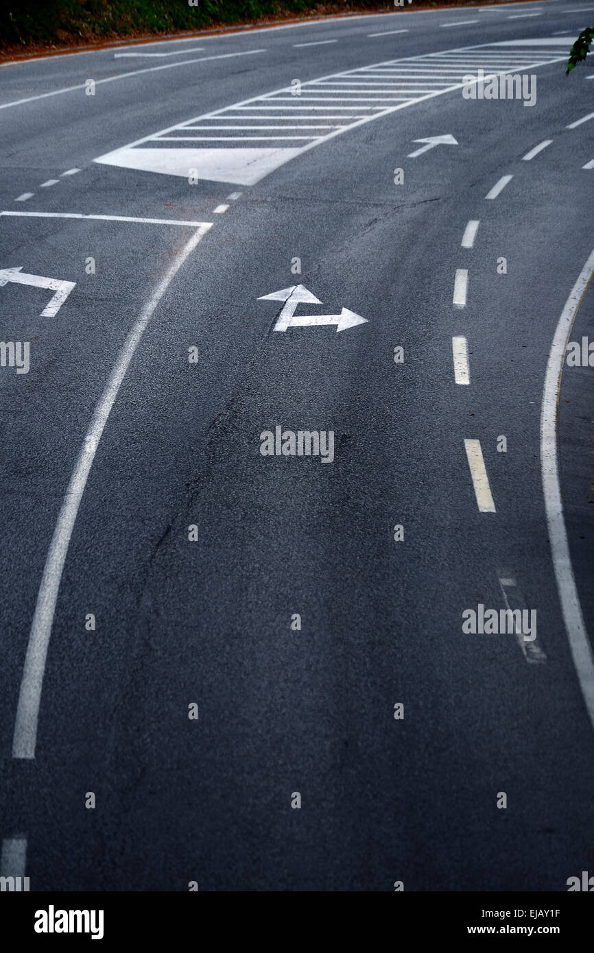 Road with turn direction lane marks Stock Photo - Alamy