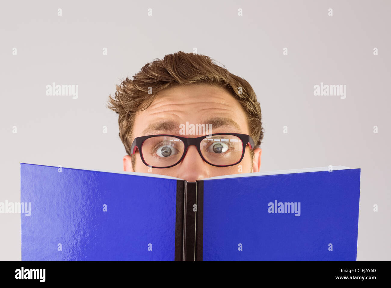 Geeky student reading a book Stock Photo - Alamy