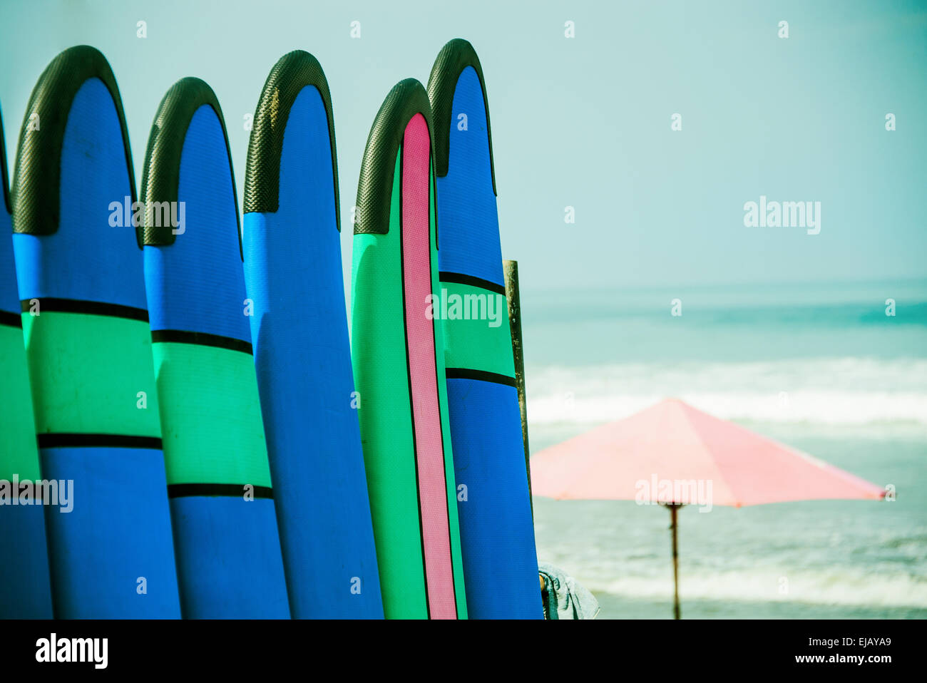 Color surf boards in a stack by ocean Stock Photo - Alamy