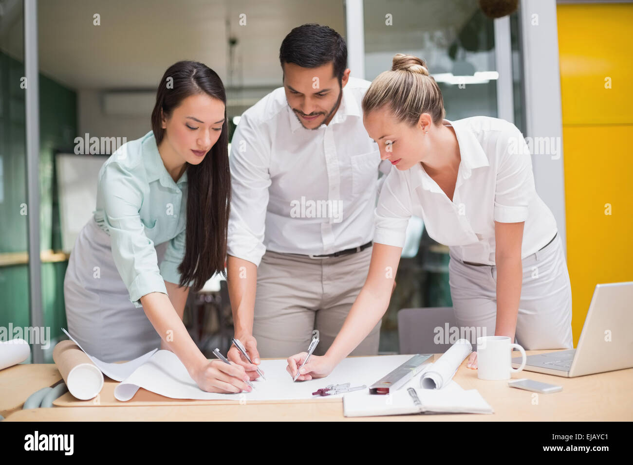 Architecture team working together at desk Stock Photo - Alamy