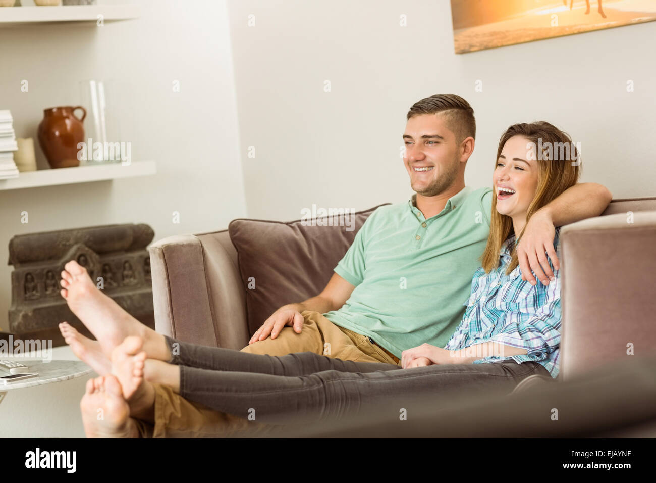 Cute couple relaxing on couch Stock Photo - Alamy