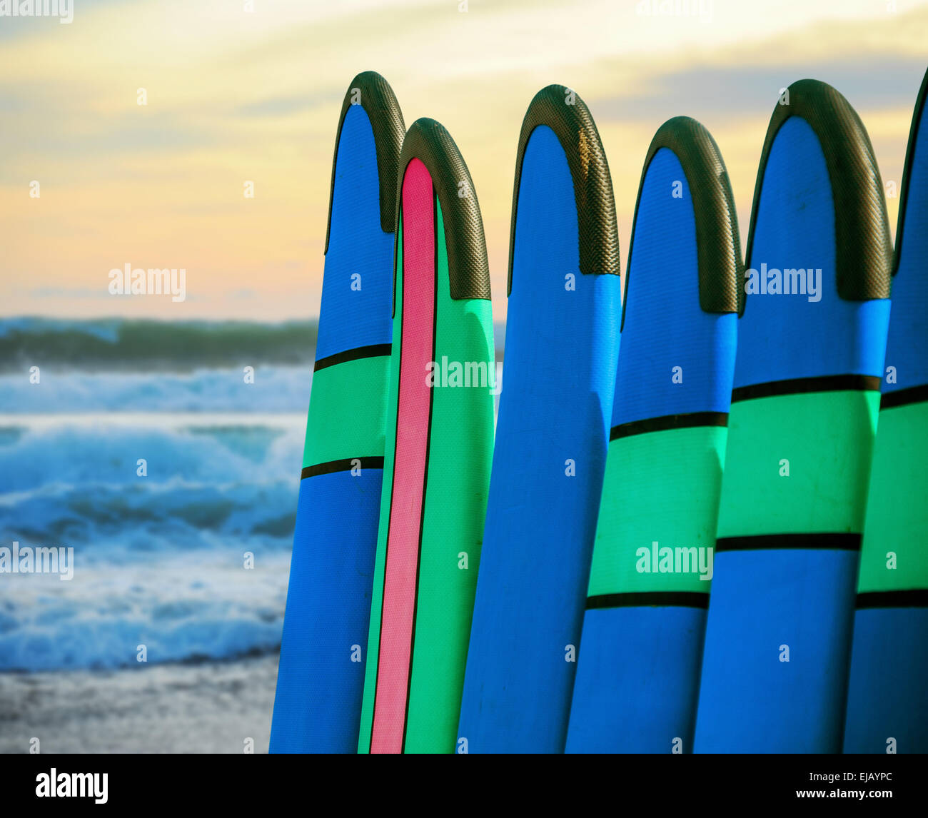 Color surf boards in a stack by ocean Stock Photo - Alamy