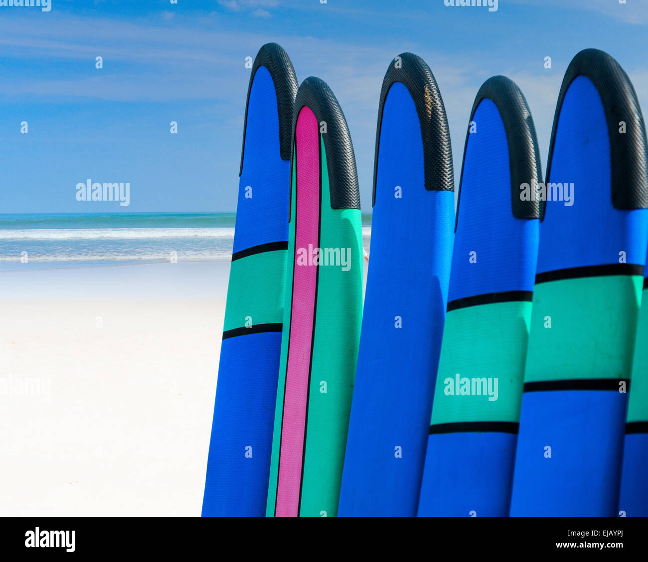 Color surf boards in a stack by ocean Stock Photo - Alamy