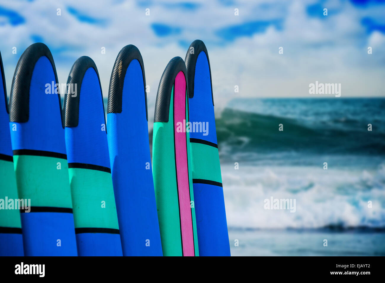 Color surf boards in a stack by ocean Stock Photo - Alamy