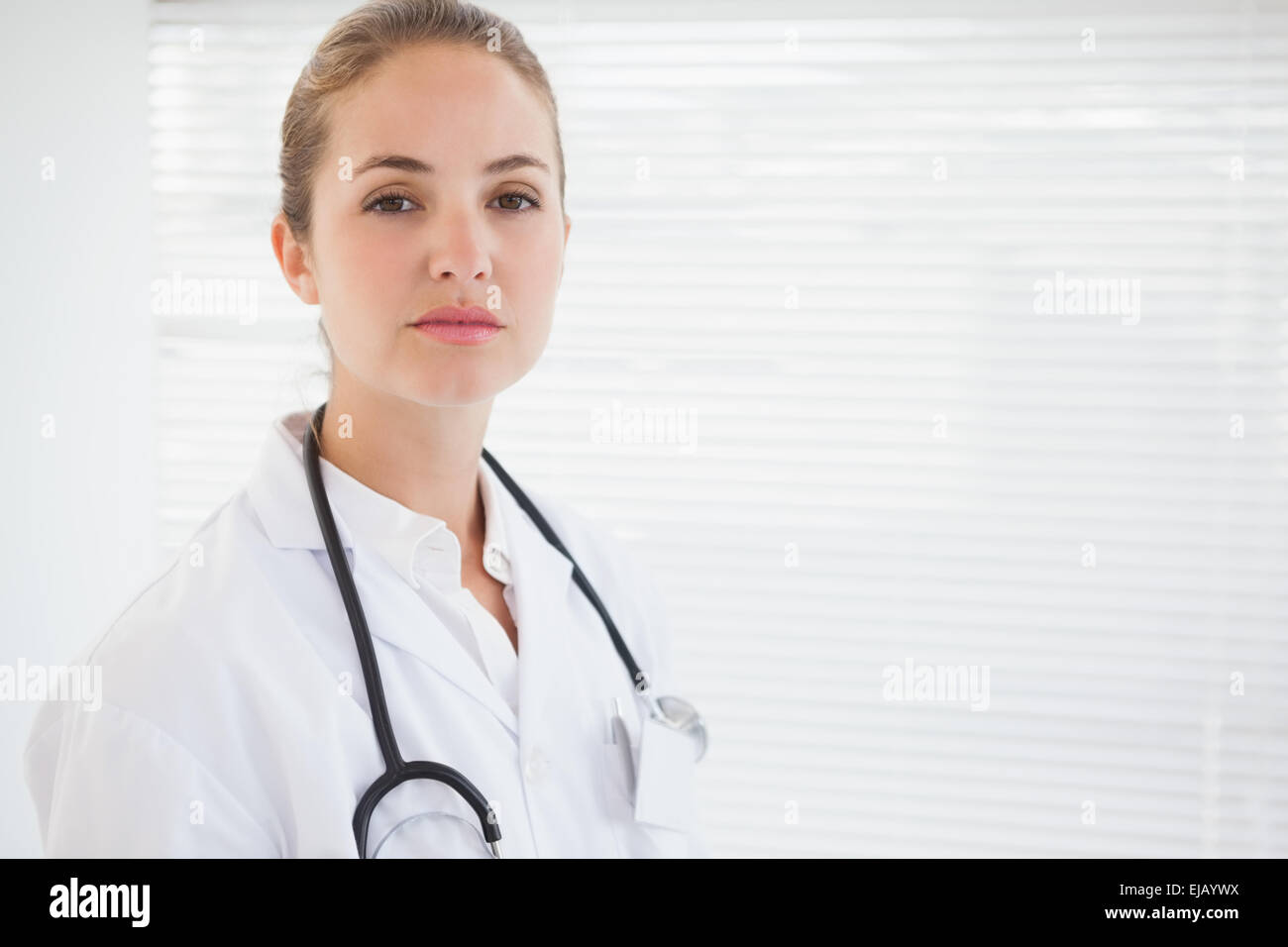 Serious doctor looking at the camera Stock Photo - Alamy