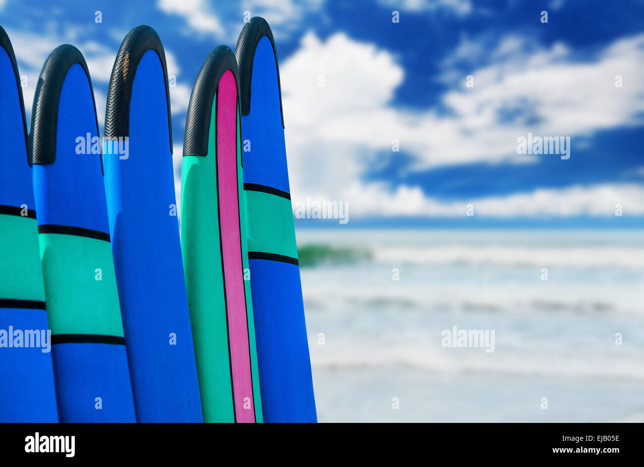 Color surf boards in a stack by ocean Stock Photo - Alamy