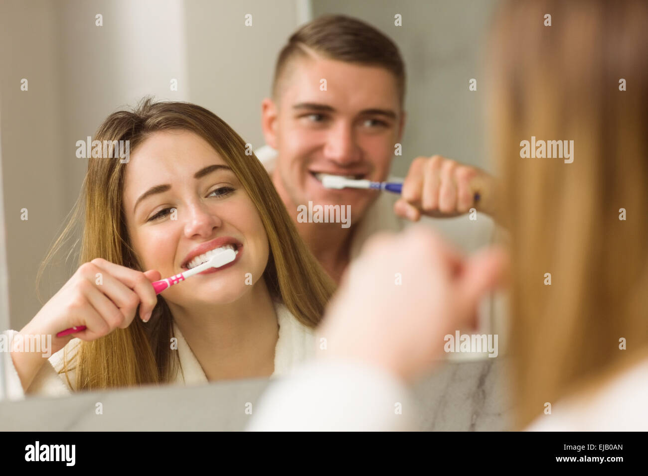 Cute couple brushing their teeth Stock Photo - Alamy