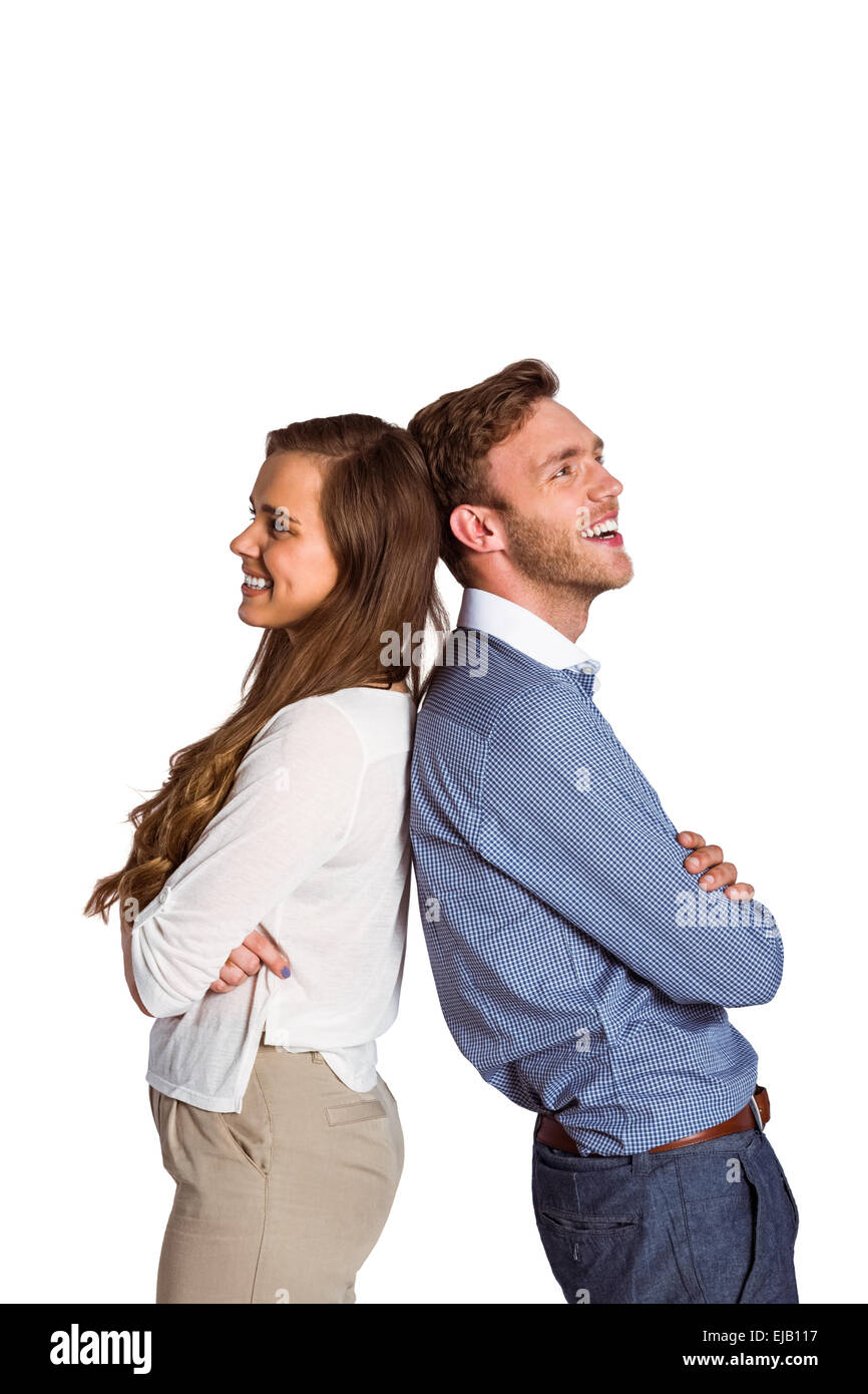 Happy young couple standing back to back Stock Photo - Alamy