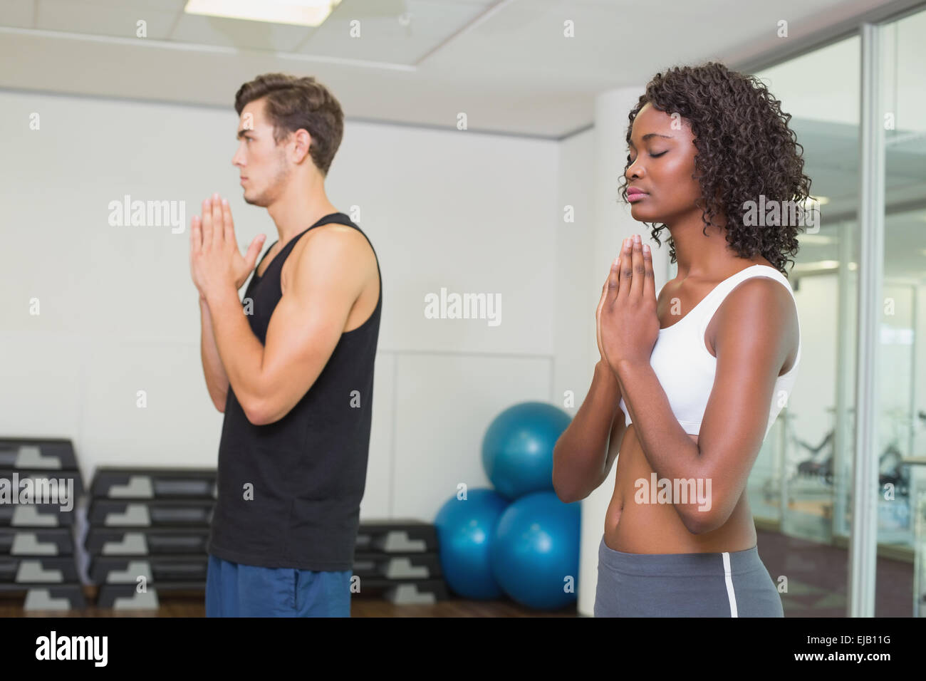 Fit couple standing with hands together Stock Photo - Alamy