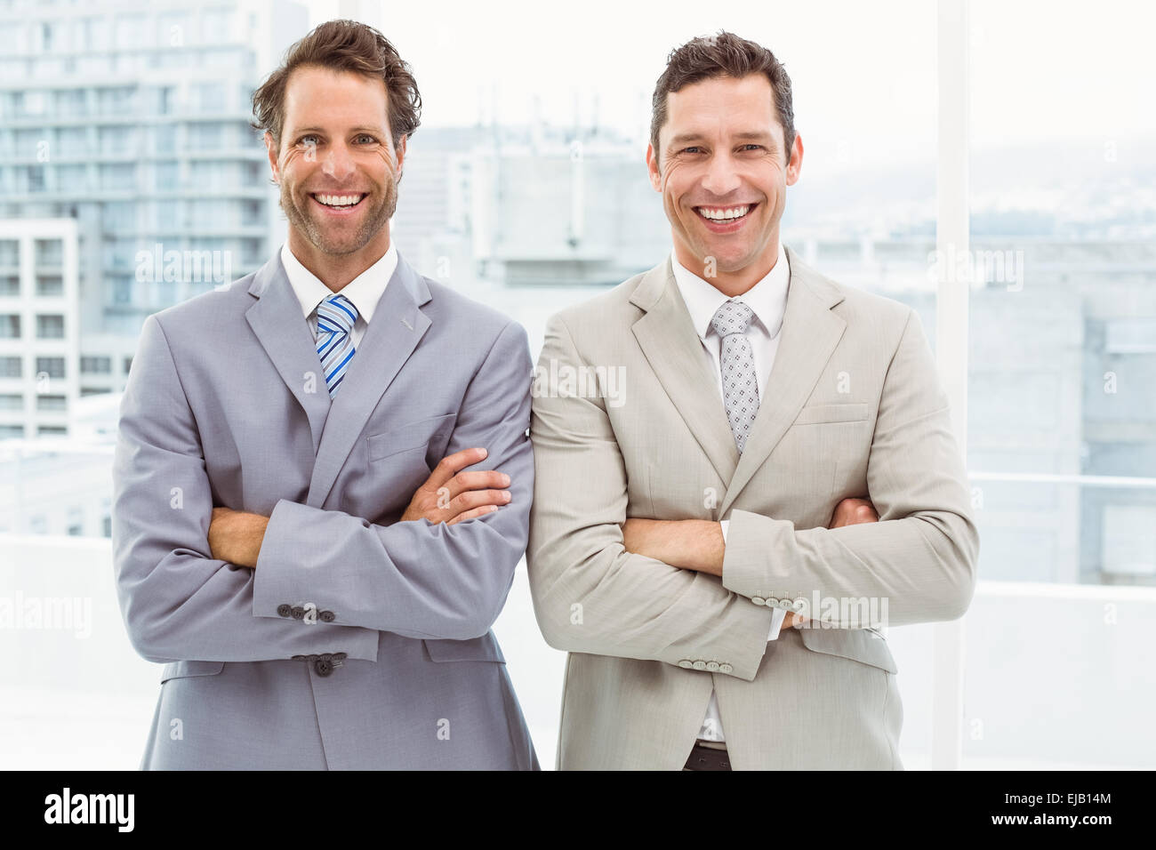 Confident happy businessmen in office Stock Photo - Alamy