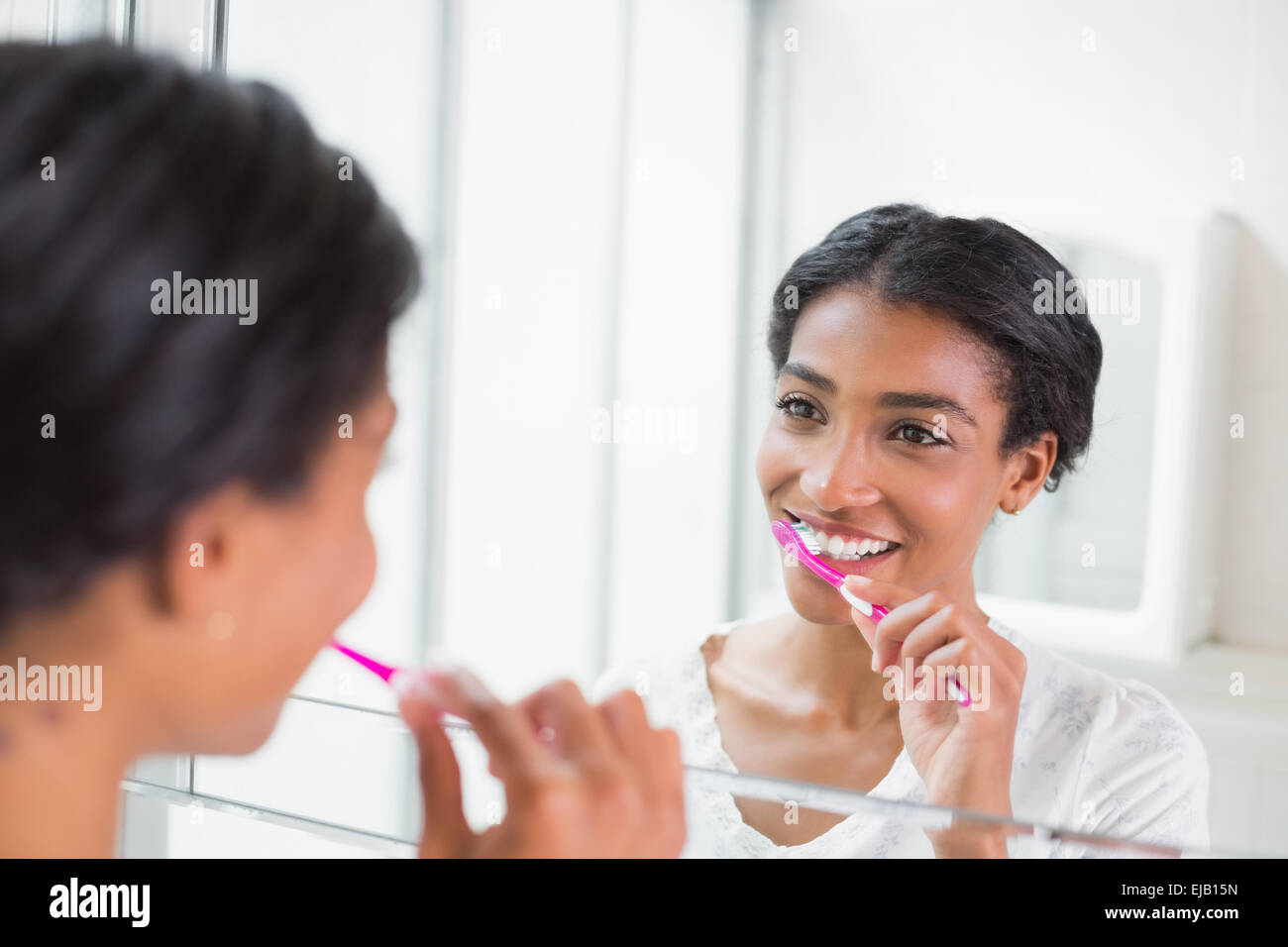 Pretty woman brushing her teeth Stock Photo - Alamy