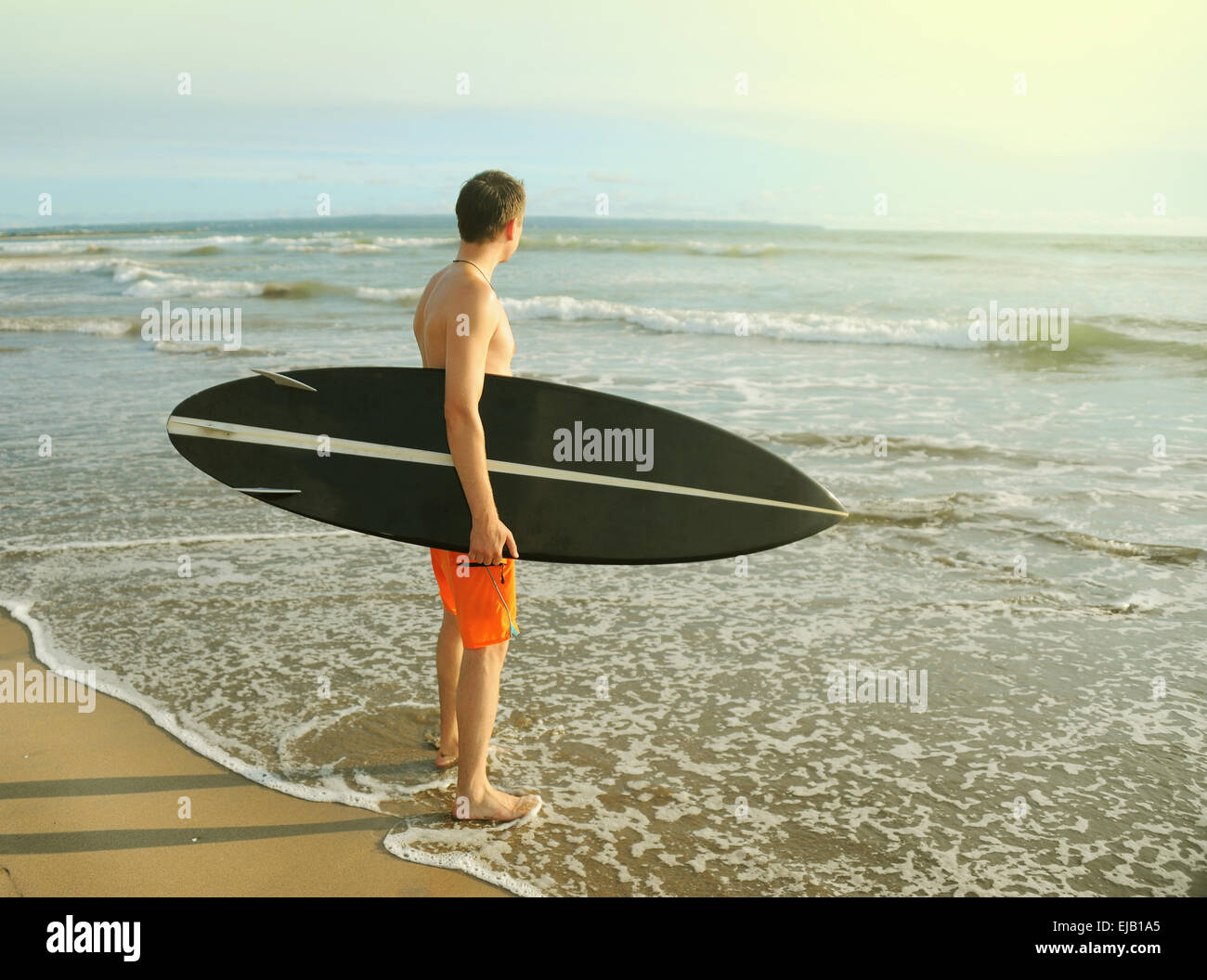 Surfer with board Stock Photo - Alamy