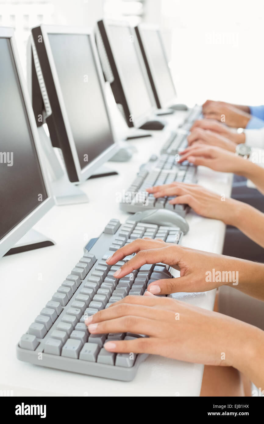 Hands using computers in office Stock Photo - Alamy